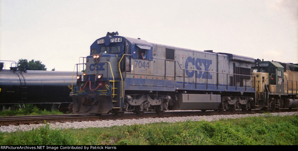 CSX 7044 C30-7 and CNW 5070 GP50 rolls past Painters and Abundance Street westbound toward the ...